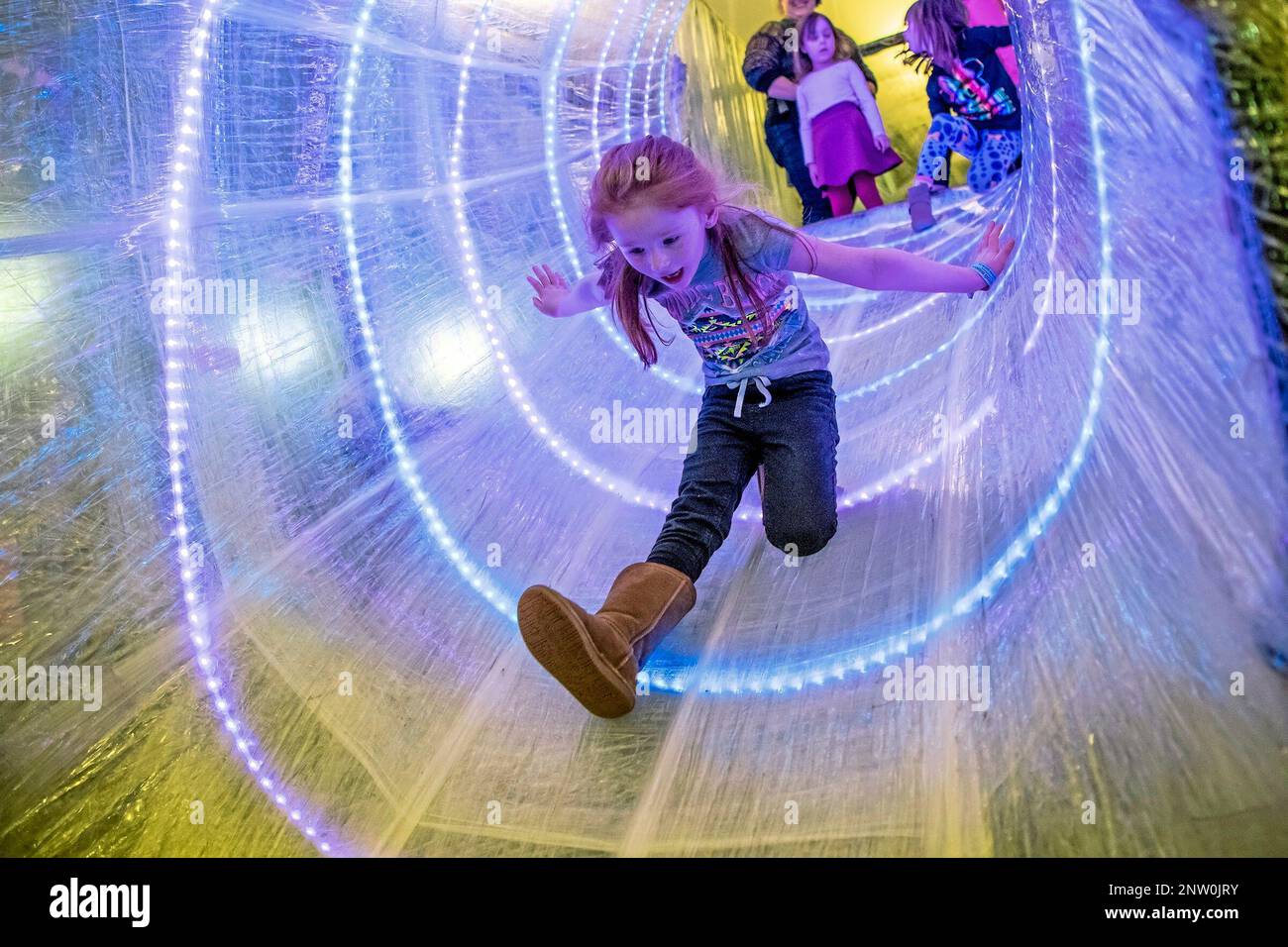 Aliza Singer, 6, of Bellevue, Pa., goes down a slide in the TapeScape 3 ...