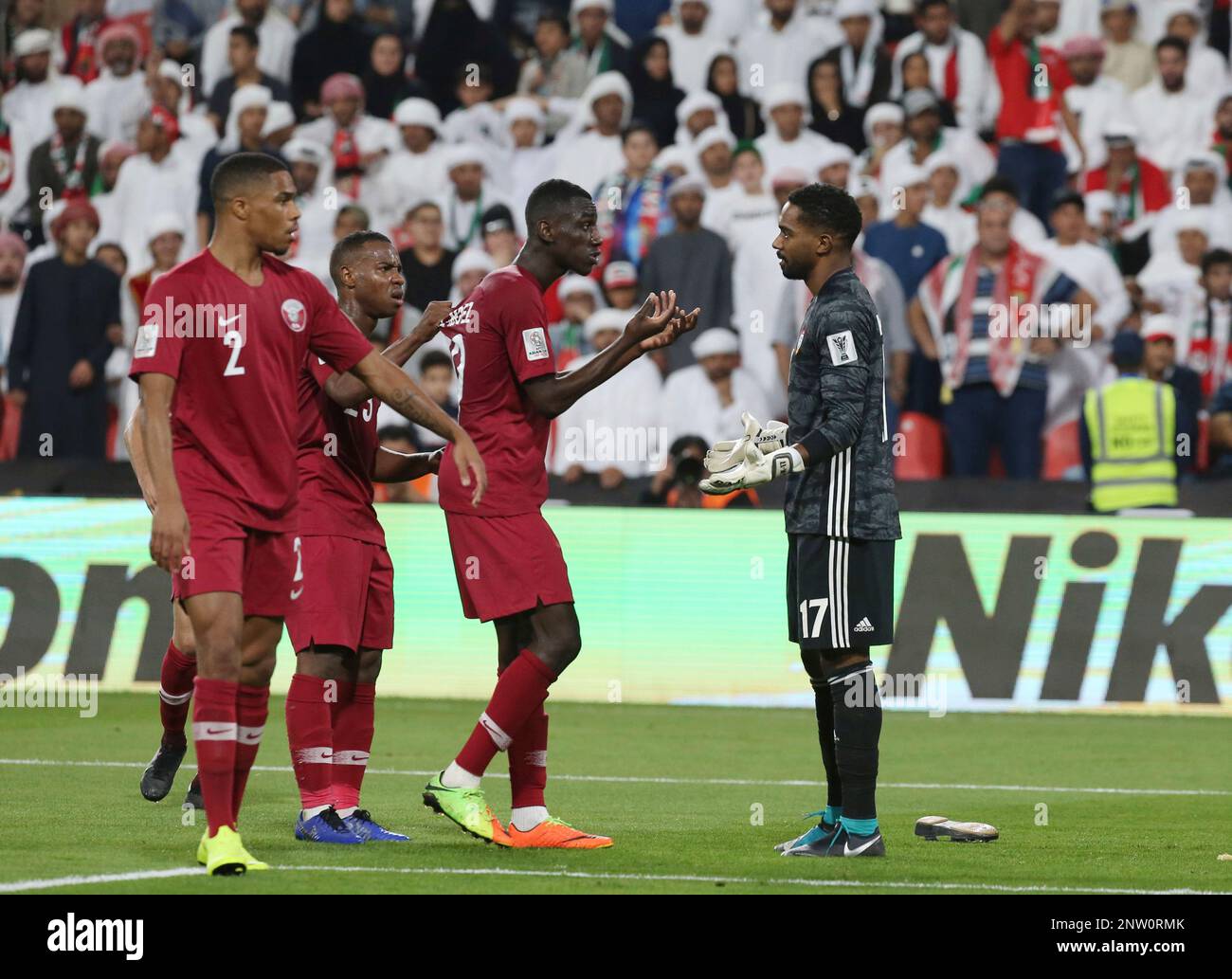 Qatar's Almoez Ali (2nd from R) talks with United Arab Emirates' GK ...