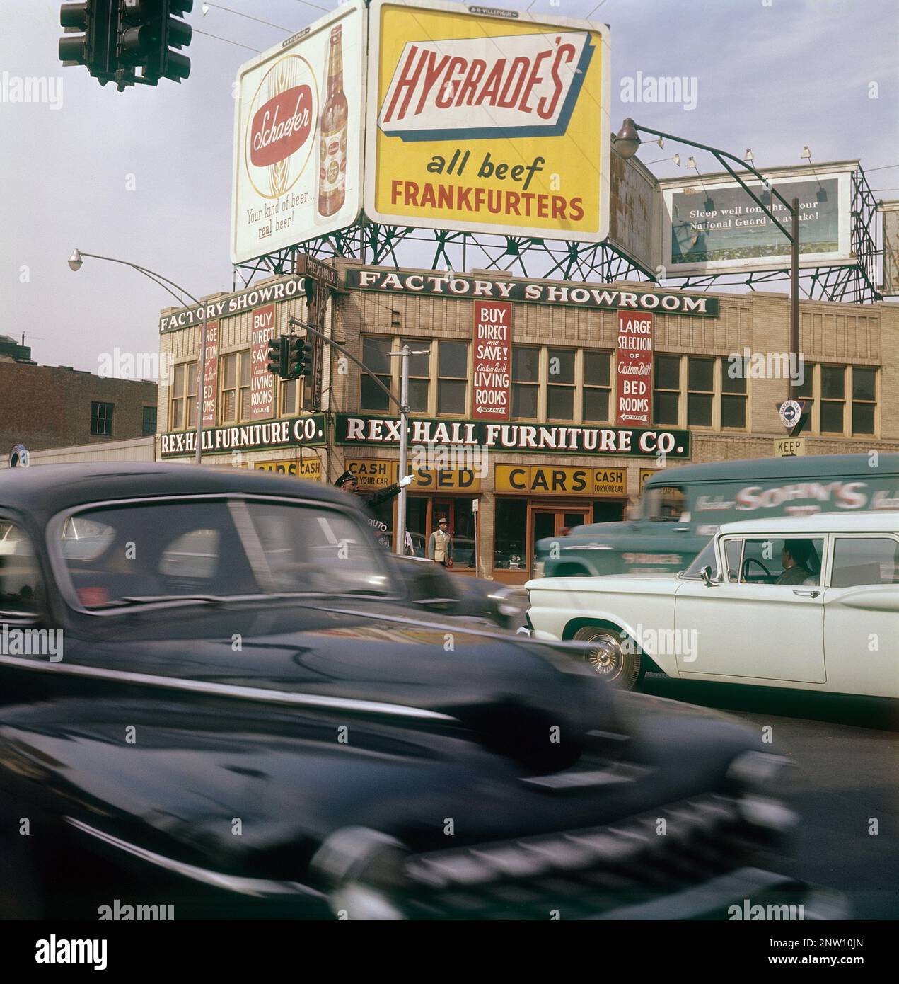 USA 1964. A street crossing in front of Rex-Hall Furniture Co and it's ...