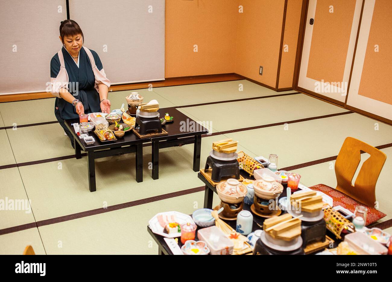 Waitress serving traditional food, Fujiya Ryokan accommodation, Kawayu ...