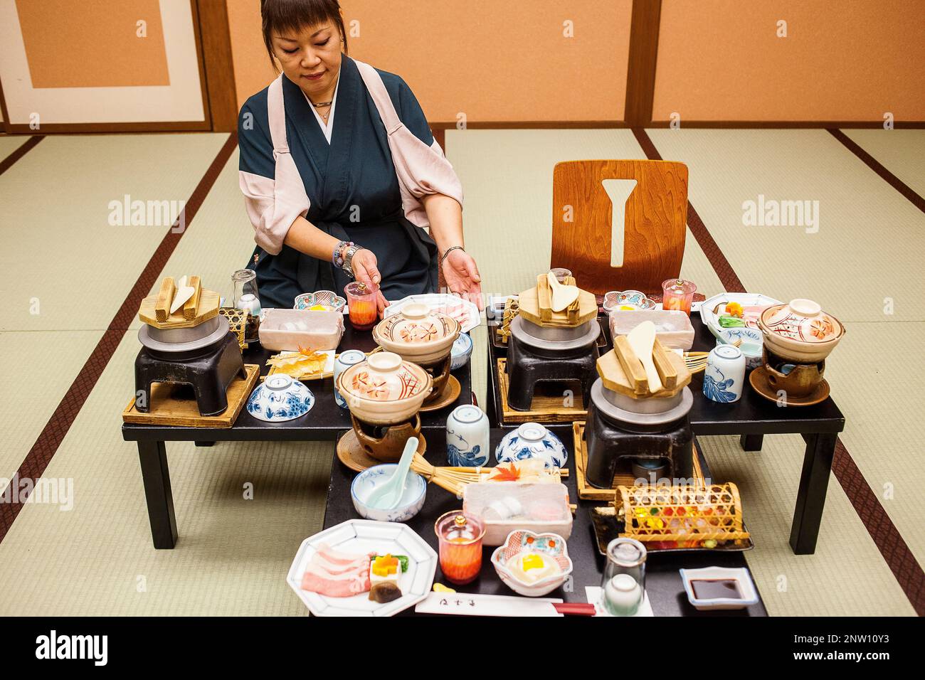 Waitress serving traditional food, Fujiya Ryokan accommodation, Kawayu ...