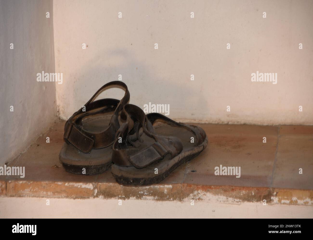 Old pair of sandals of a monk on a window inside the cell of a ...
