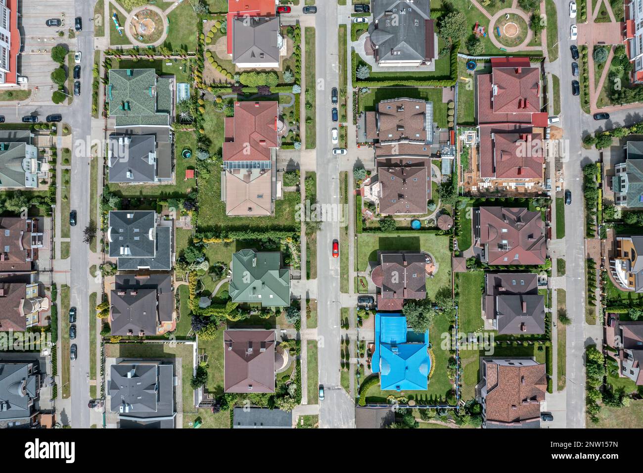 top down view of houses roofs in suburb area on sunny day. aerial ...