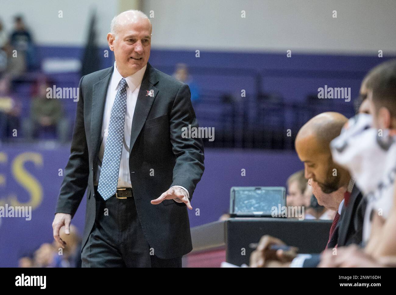 Northeastern head coach Bill Coen talks with his assistants during the ...