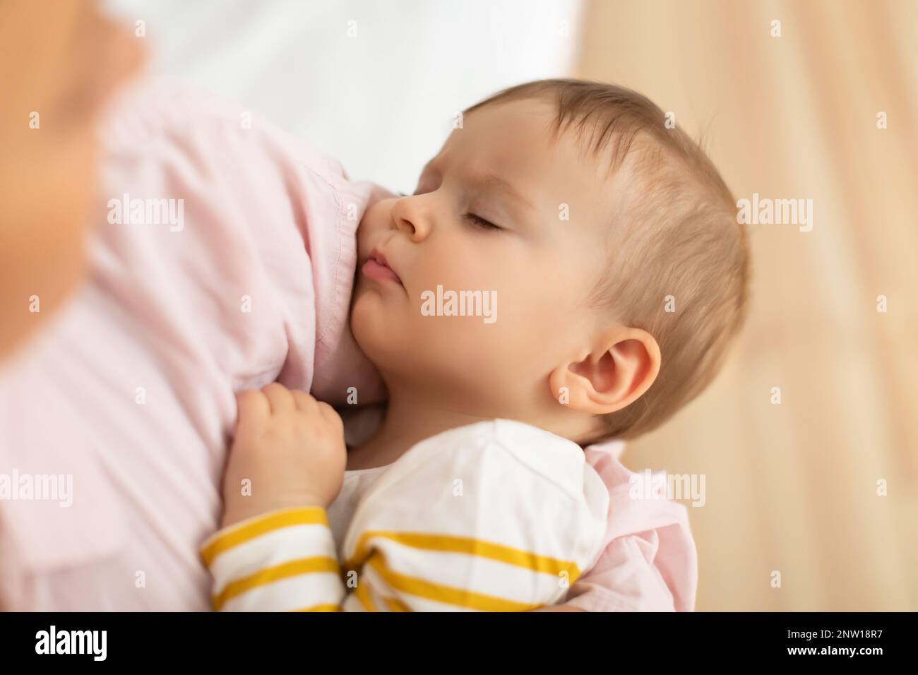 Closeup portrait of adorable sleeping baby girl in mother's arms ...