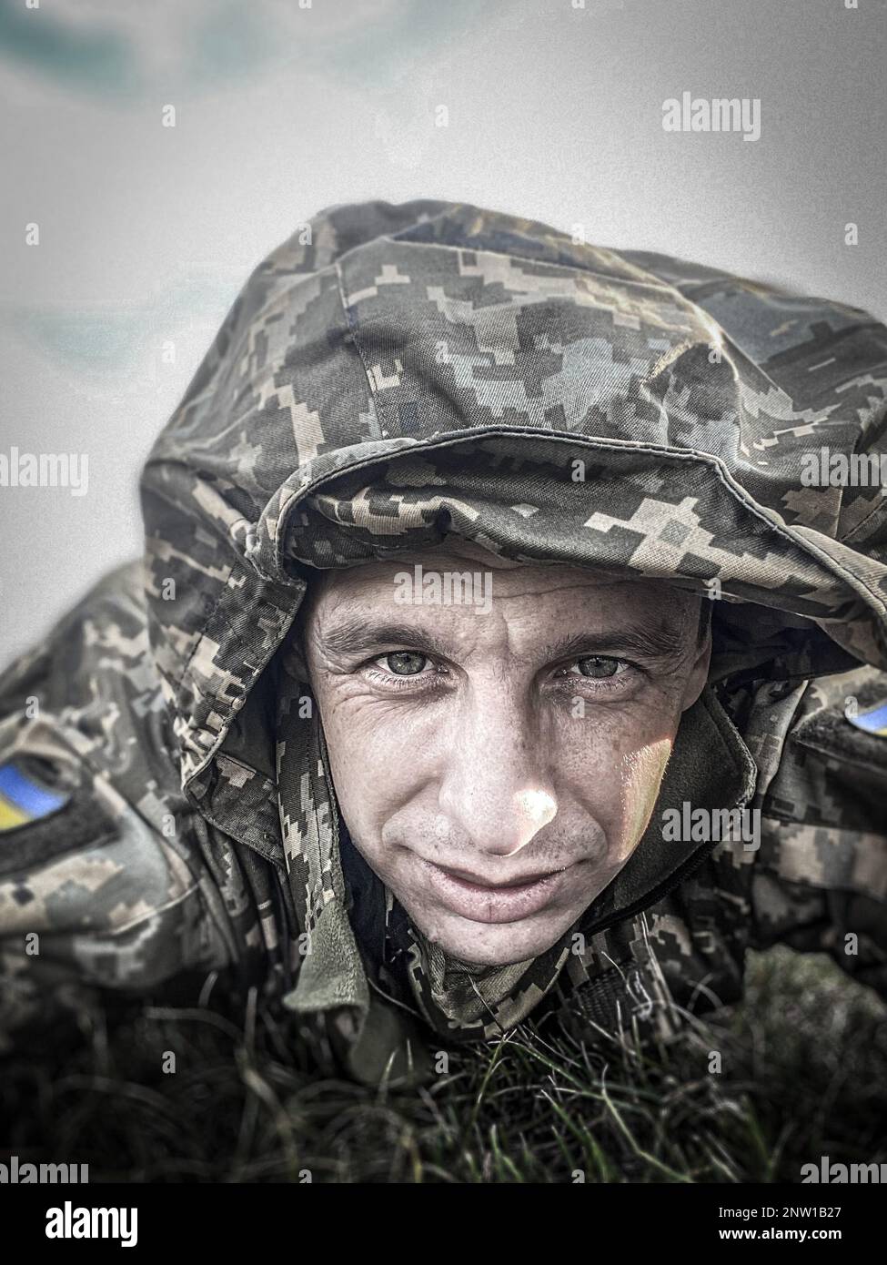 Portrait of Ukrainian military soldier in a pixelated uniform, smiling ...