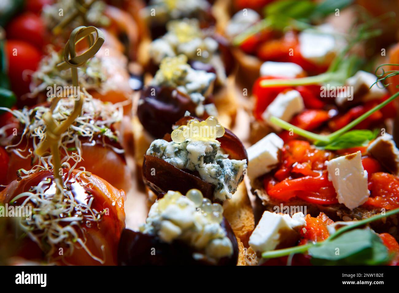 Gourmet snack food catering. Exotic canapes with caviar, blue cheese ...