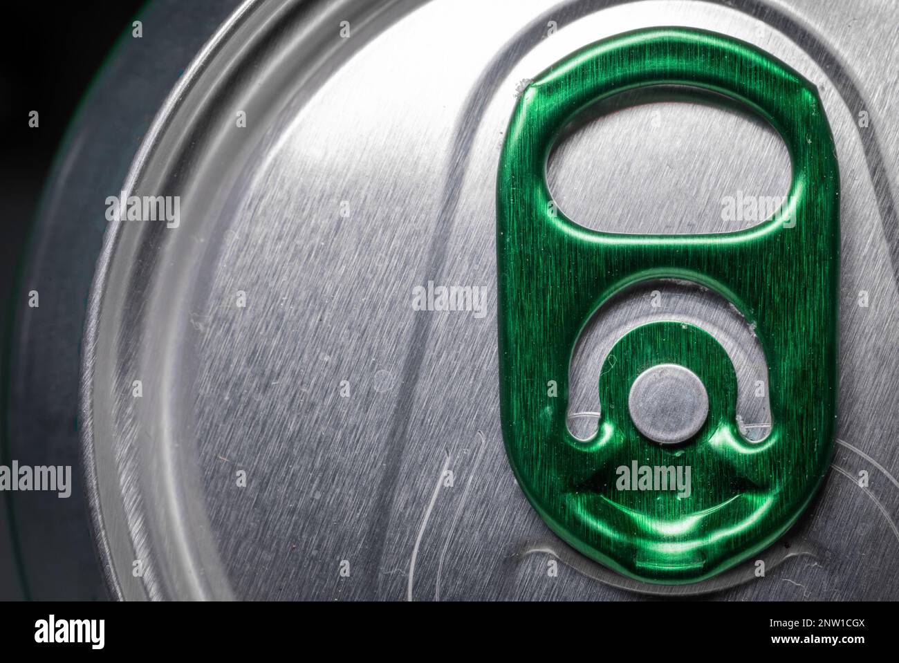 Macro or detail photo of an aluminium can with ring pull in green color ...