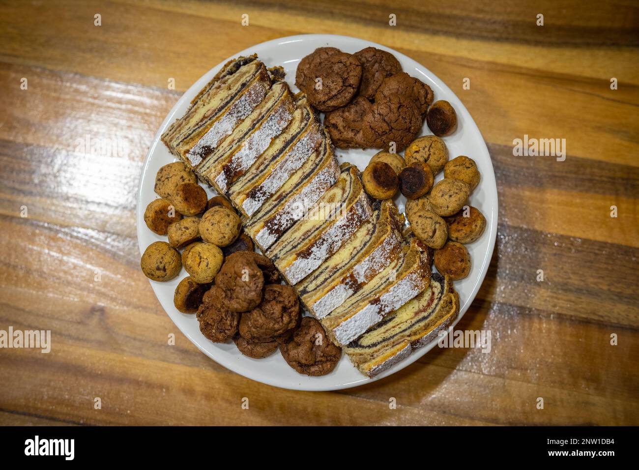 Plate of home made sweets as cookies, potica, cake and similar seen ...