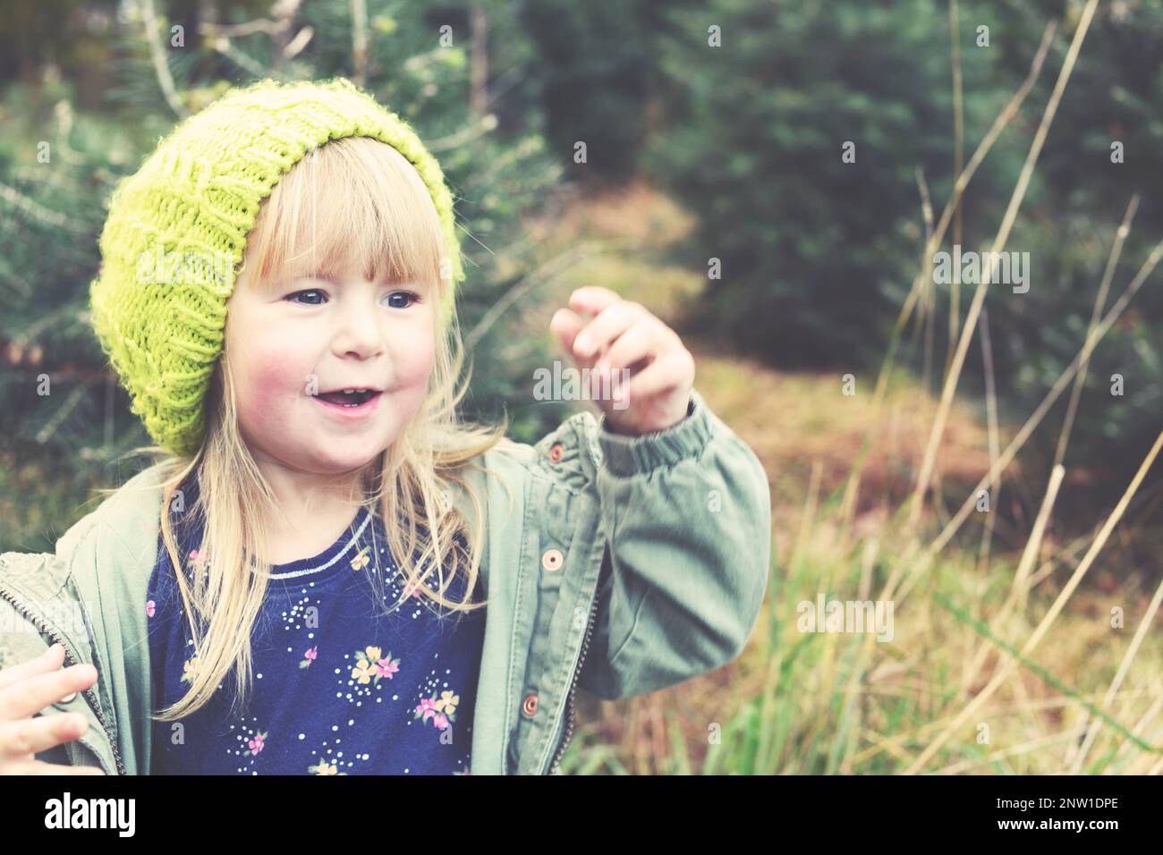 Young child in tree field loving life Stock Photo - Alamy