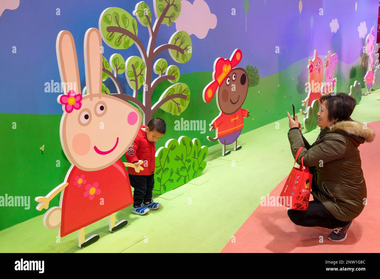 A boy poses for photos inside a Peppa Pig pop-up shop in Shanghai ...