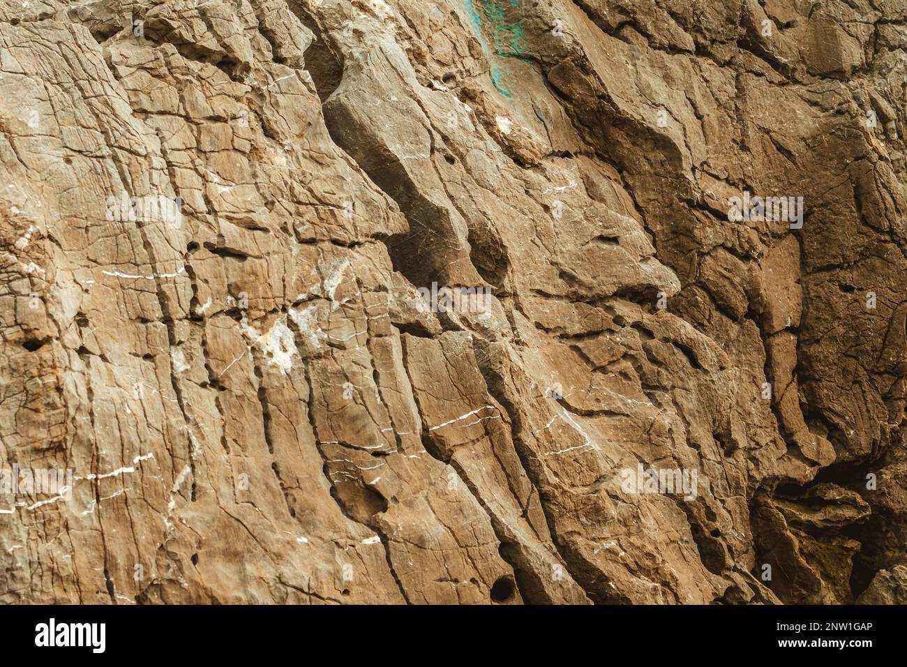 Texture of rough brown rock cliff as natural background Stock Photo - Alamy