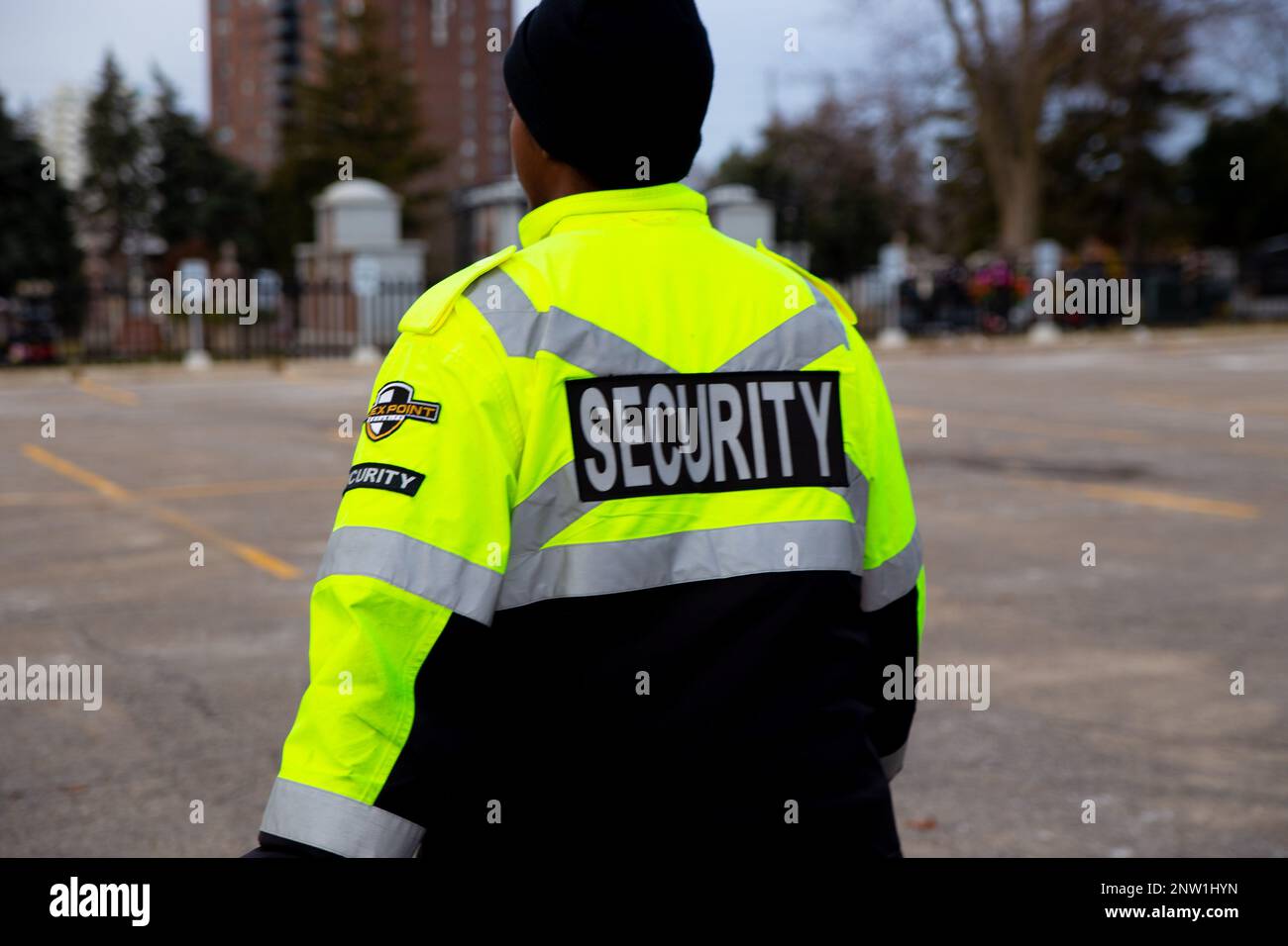 Security guard setting up a caution tape to do parking enforcement at guest parking lot Stock ...