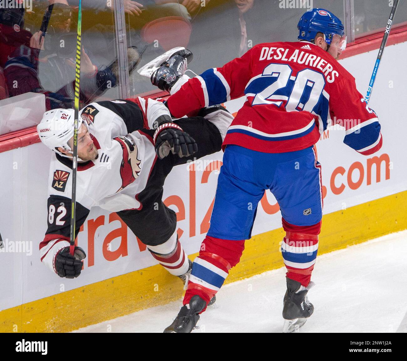 Arizona Coyotes defenseman Jordan Oesterle (82) is checked by Montreal ...