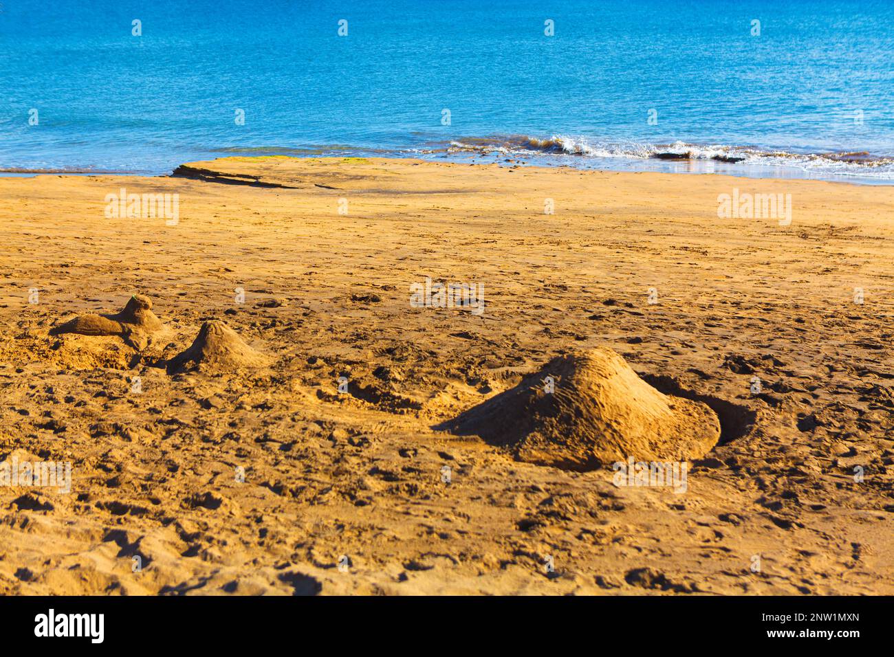 Sandy figures on the beach . Golden sand coast Stock Photo - Alamy