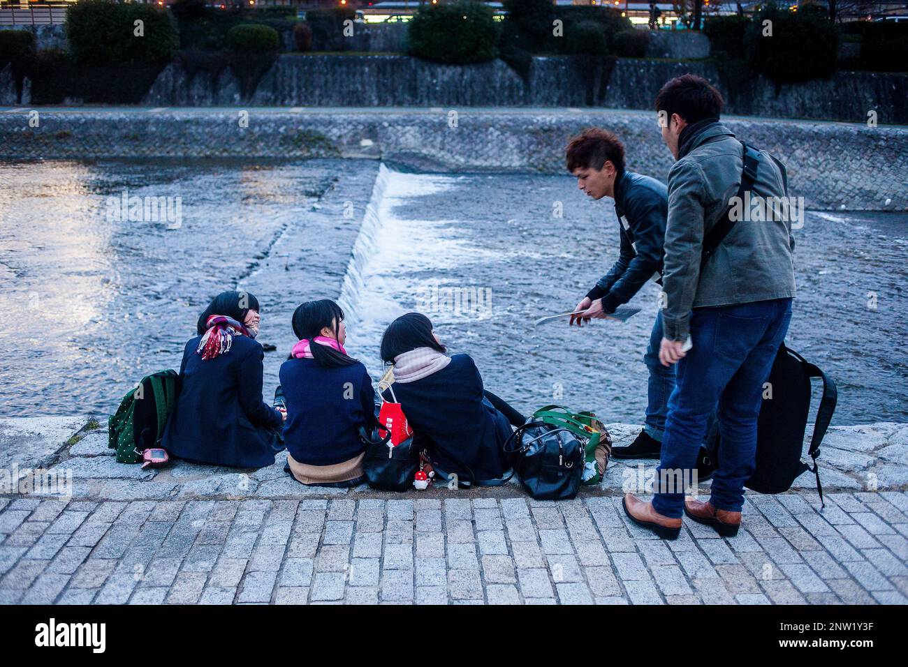 Men talking to girls,Kamo river at Pontocho,Kyoto, Japan Stock Photo ...