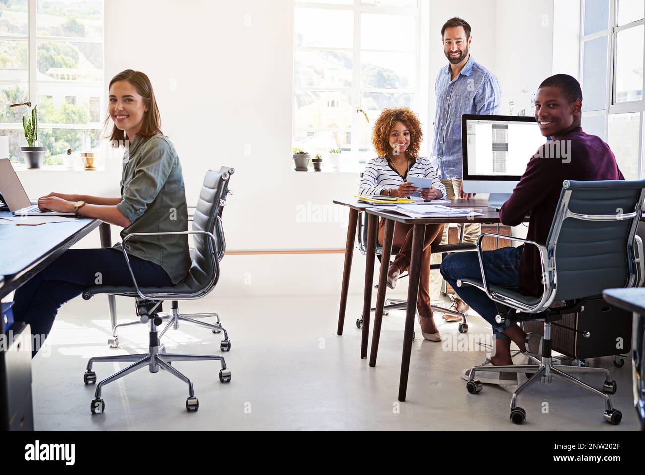 Our office layout improves productivity. Portrait of a team of ...