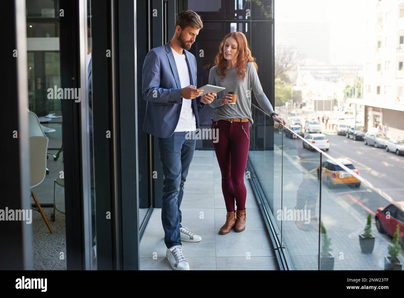 Tackling tasks with the help of technology. Cropped shot of two young ...