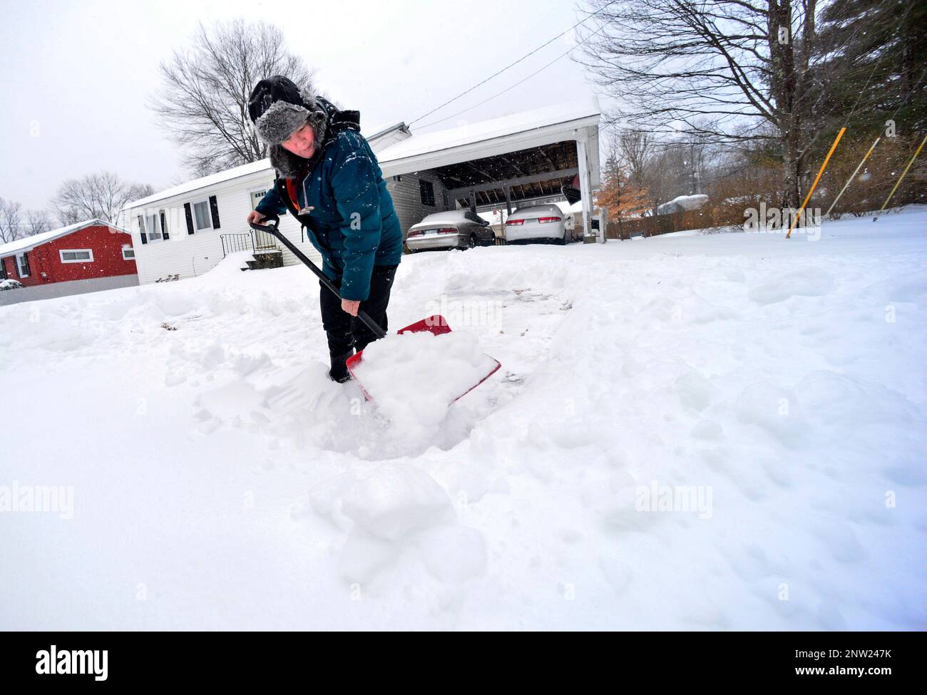 Sharon Meany, of Keene, N.H., works on removing the snow from the mouth ...