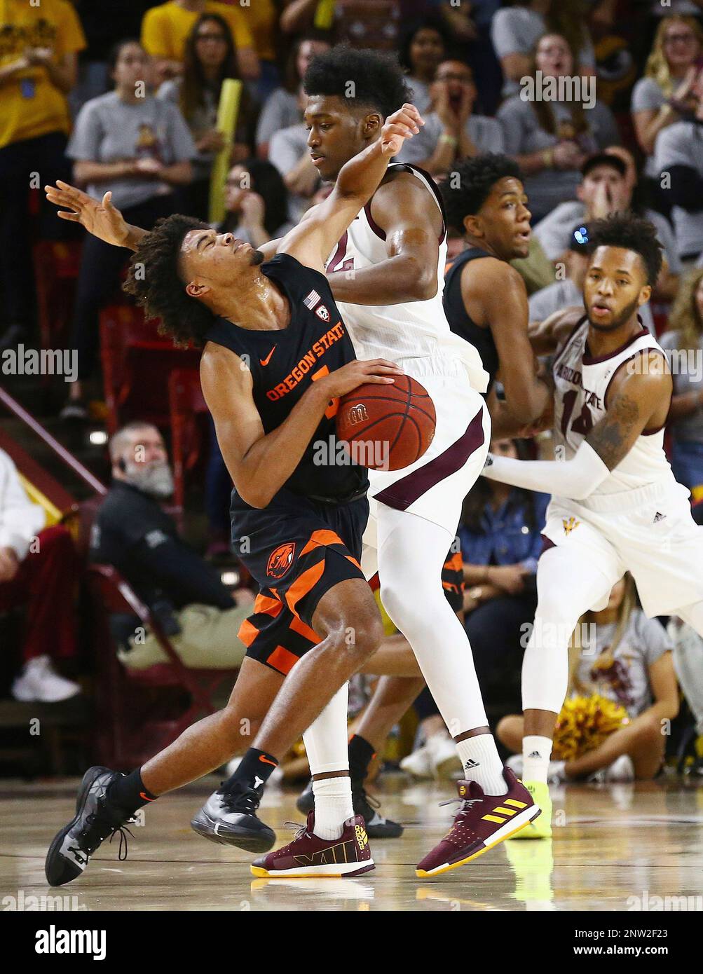 Oregon State guard Ethan Thompson, left, is fouled by Arizona State ...