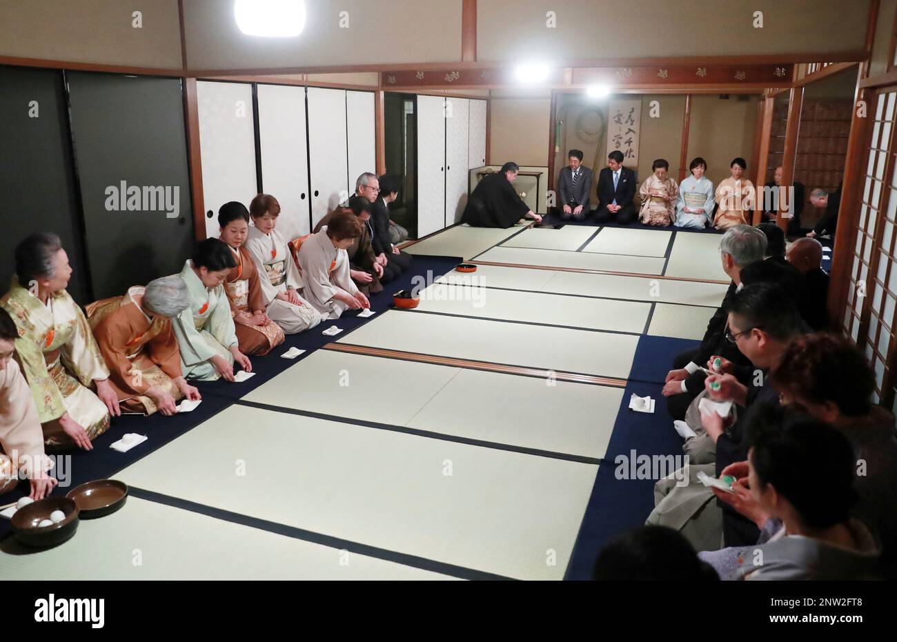 Japan's Prime Minister Shinzo Abe( back left) attends the Hatsugama ...