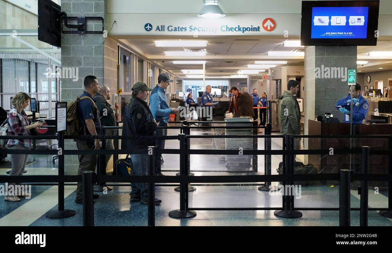 Travellers wait in a short line as they enter the TSA checkpoint at the ...