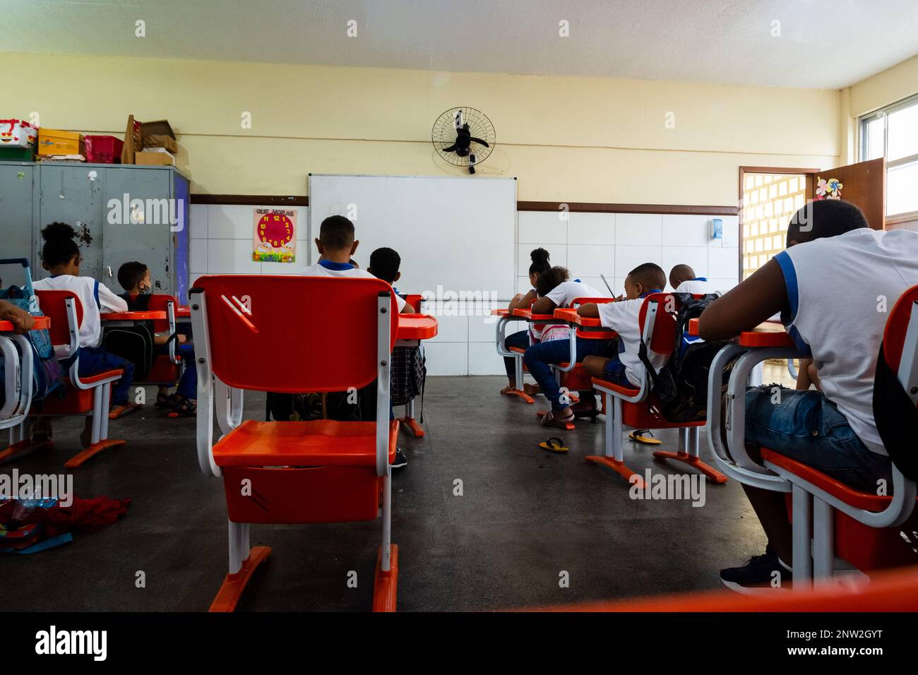 Students at a public school, from the back, taking an exam on their ...