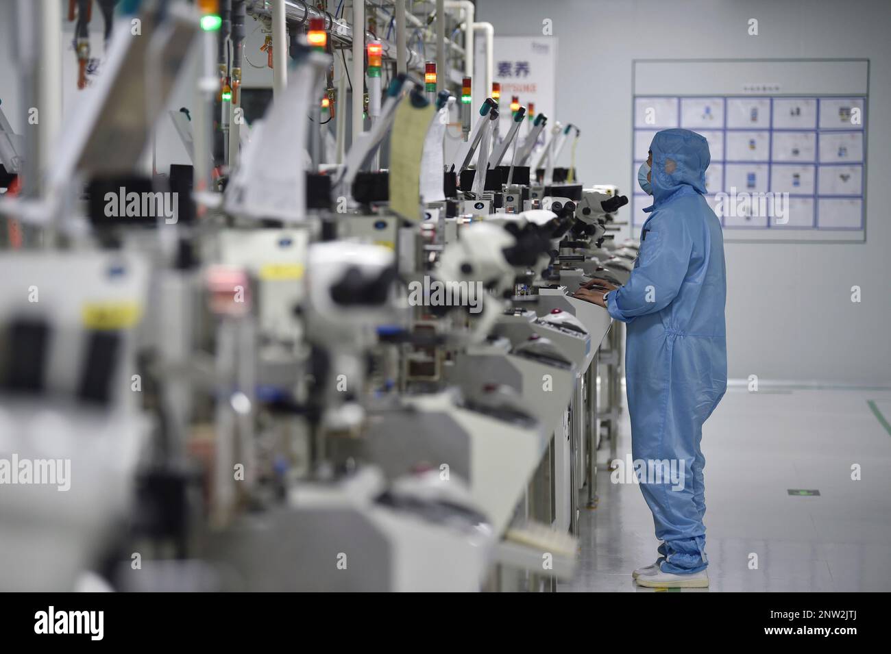 A worker monitors the production at a semiconductor manufacturer in ...