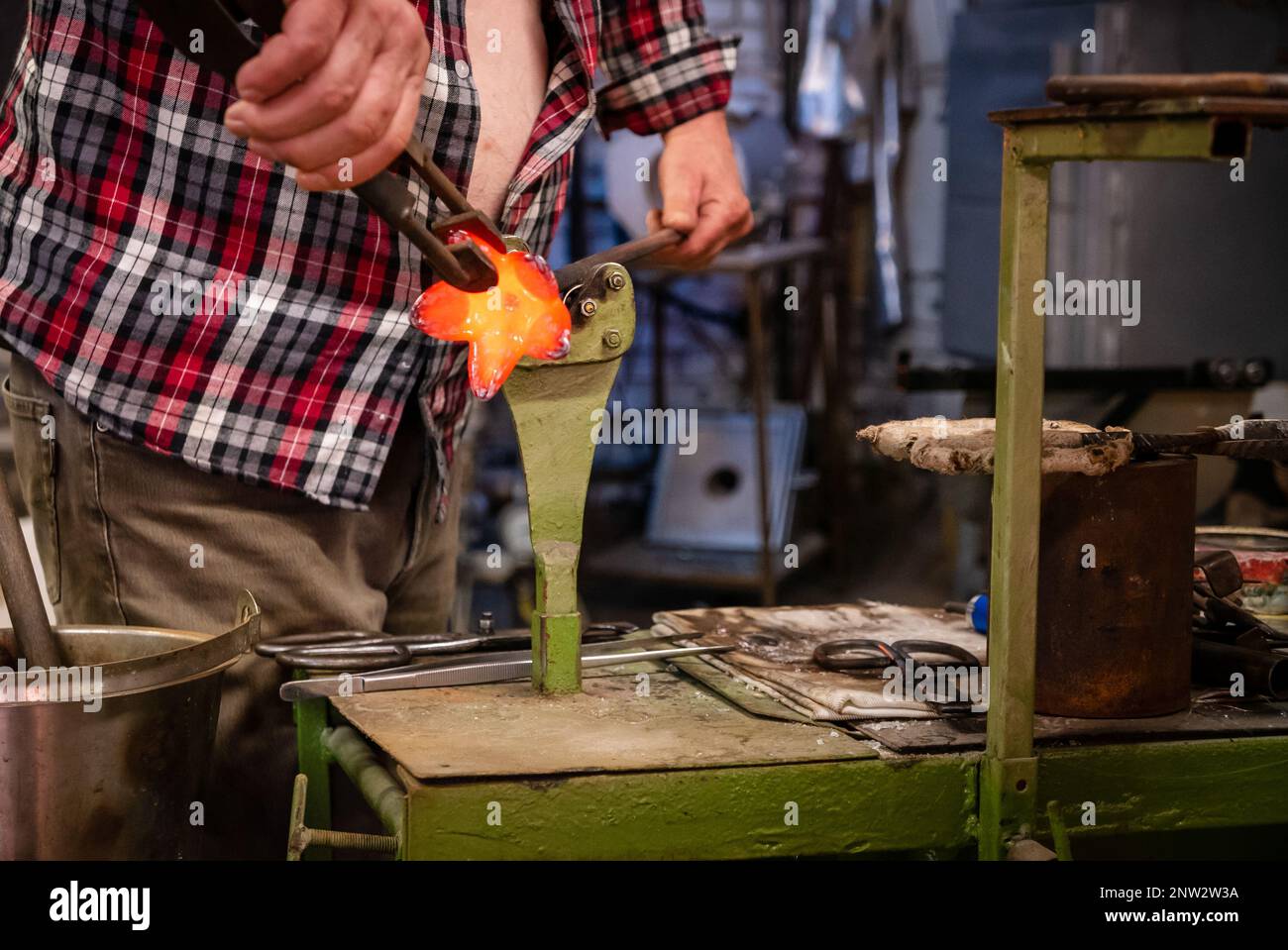 A glassworks worker shows traditional methods of making decorative ...