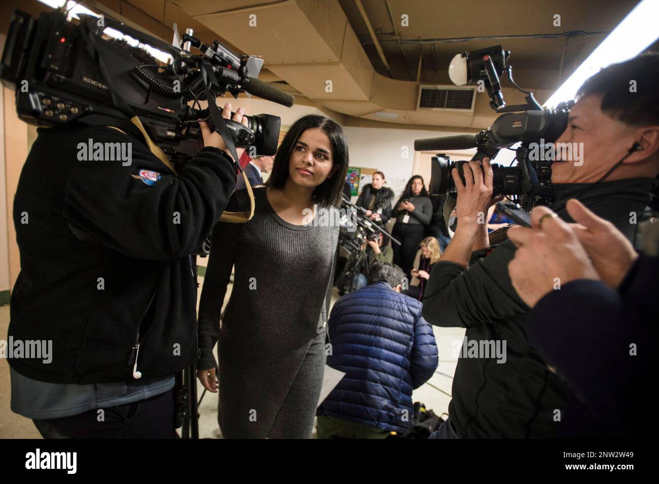 Rahaf Mohammed makes her way through a crowd of media after giving a public statement in Toronto ...