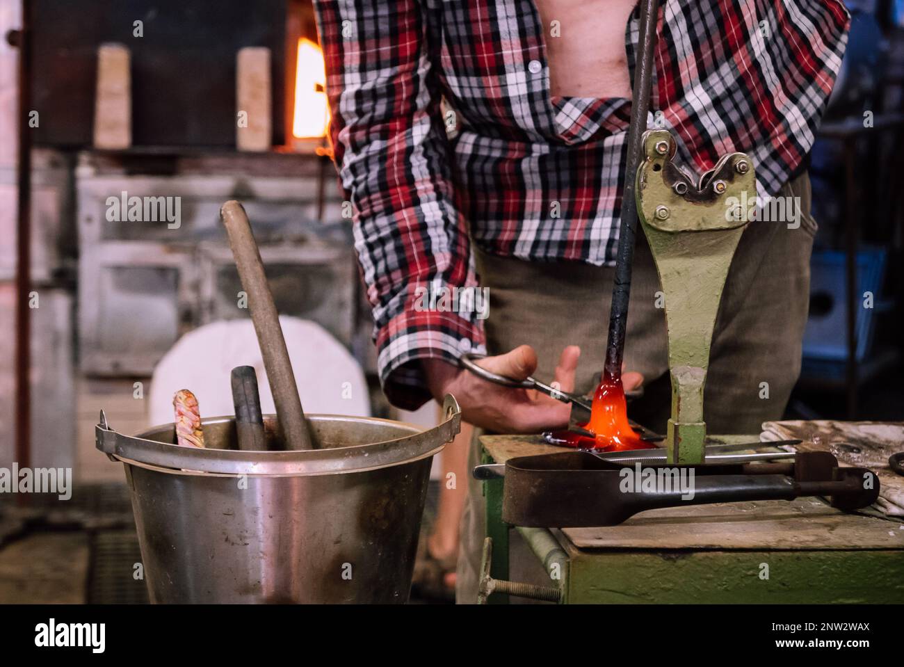 A glassworks worker shows traditional methods of making decorative ...