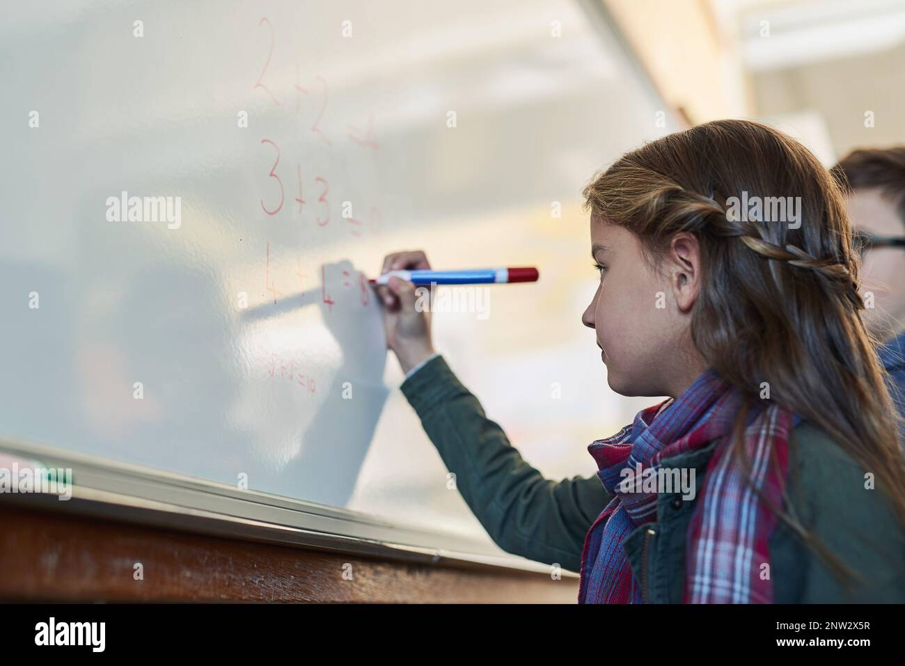 Shes got a bright young mind. Shot of an elementary school girl writing ...