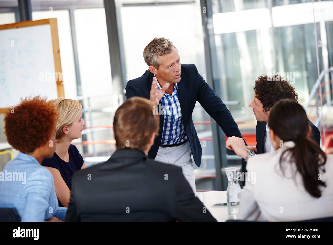Distributing tasks to the team. Cropped shot of a group of business ...