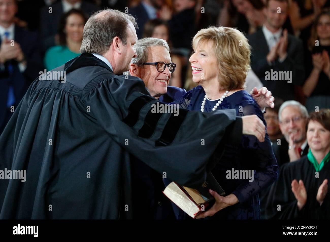Ohio Governor Mike DeWine, center, reacts after taking the oath of ...