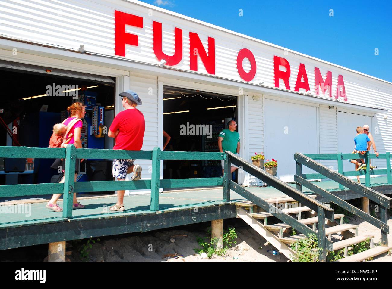 People gather outside Fun O Rama, an arcade on the beach on the coast ...