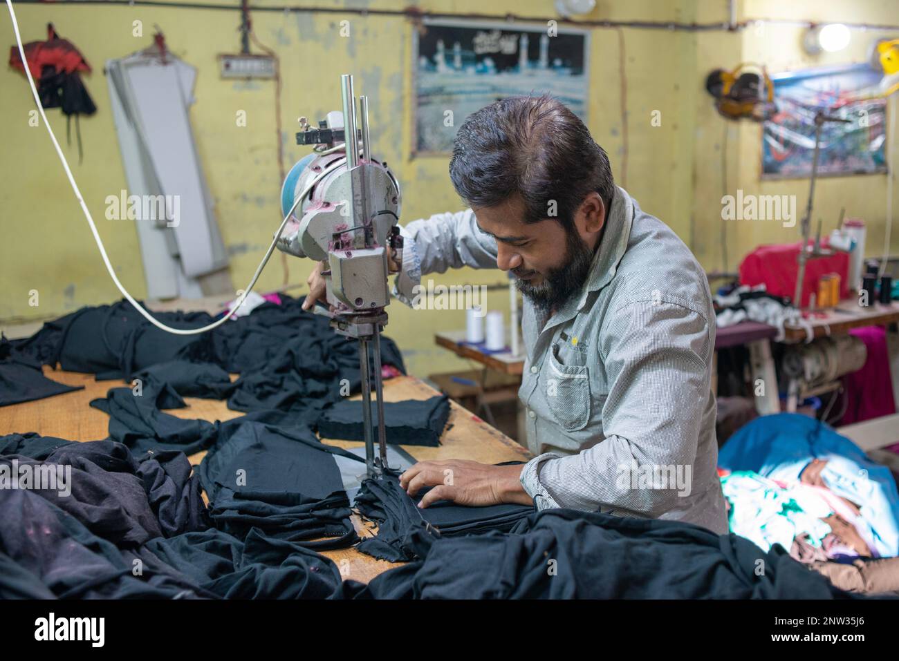 Dhaka, Bangladesh. 28th Feb, 2023. A man working in a local garment ...