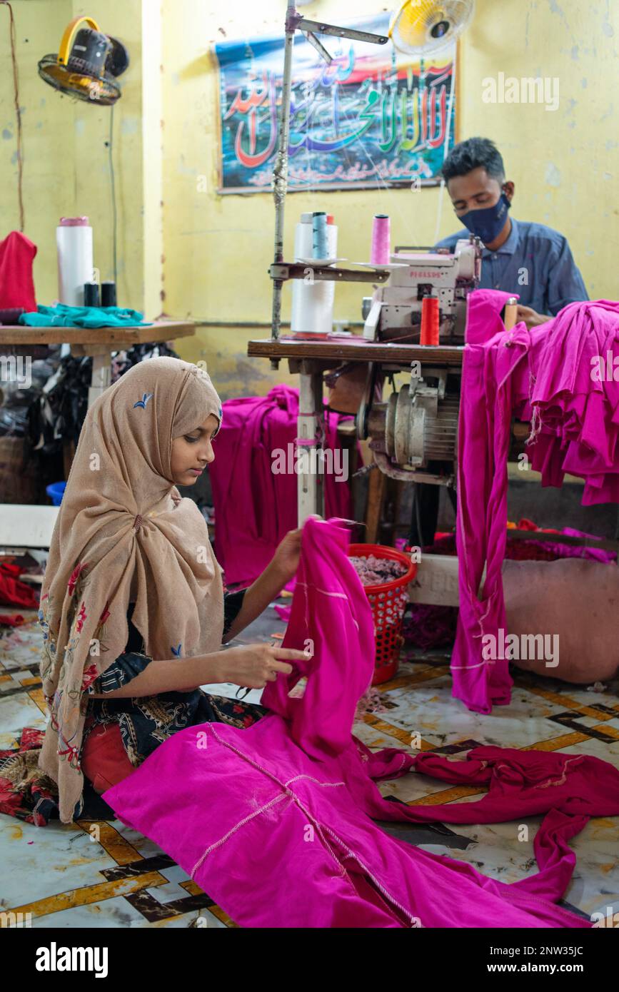 Dhaka, Bangladesh. 28th Feb, 2023. A teenage girl working besides her ...