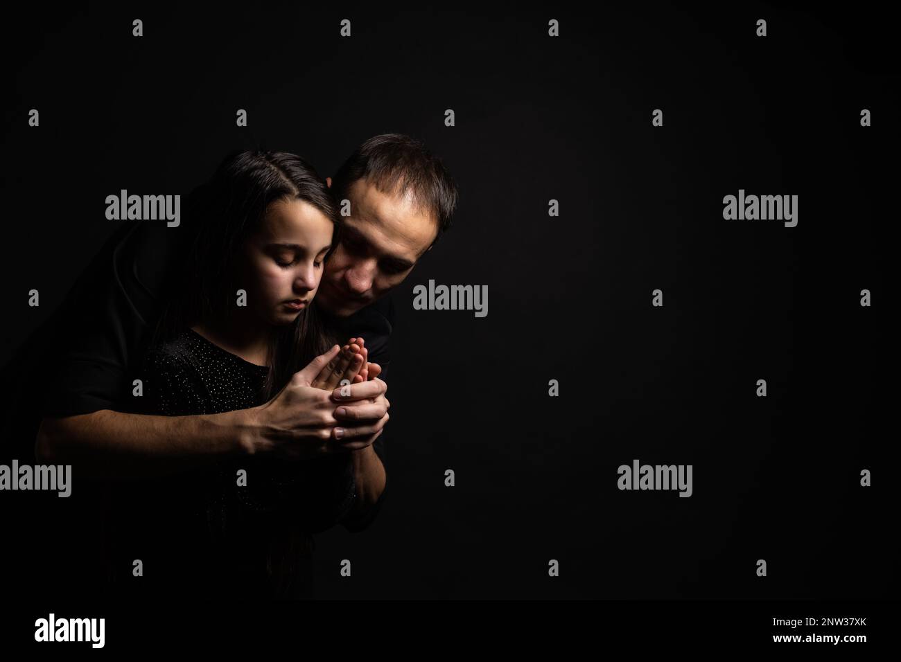 Young father and daughter praying with hands together with hope ...