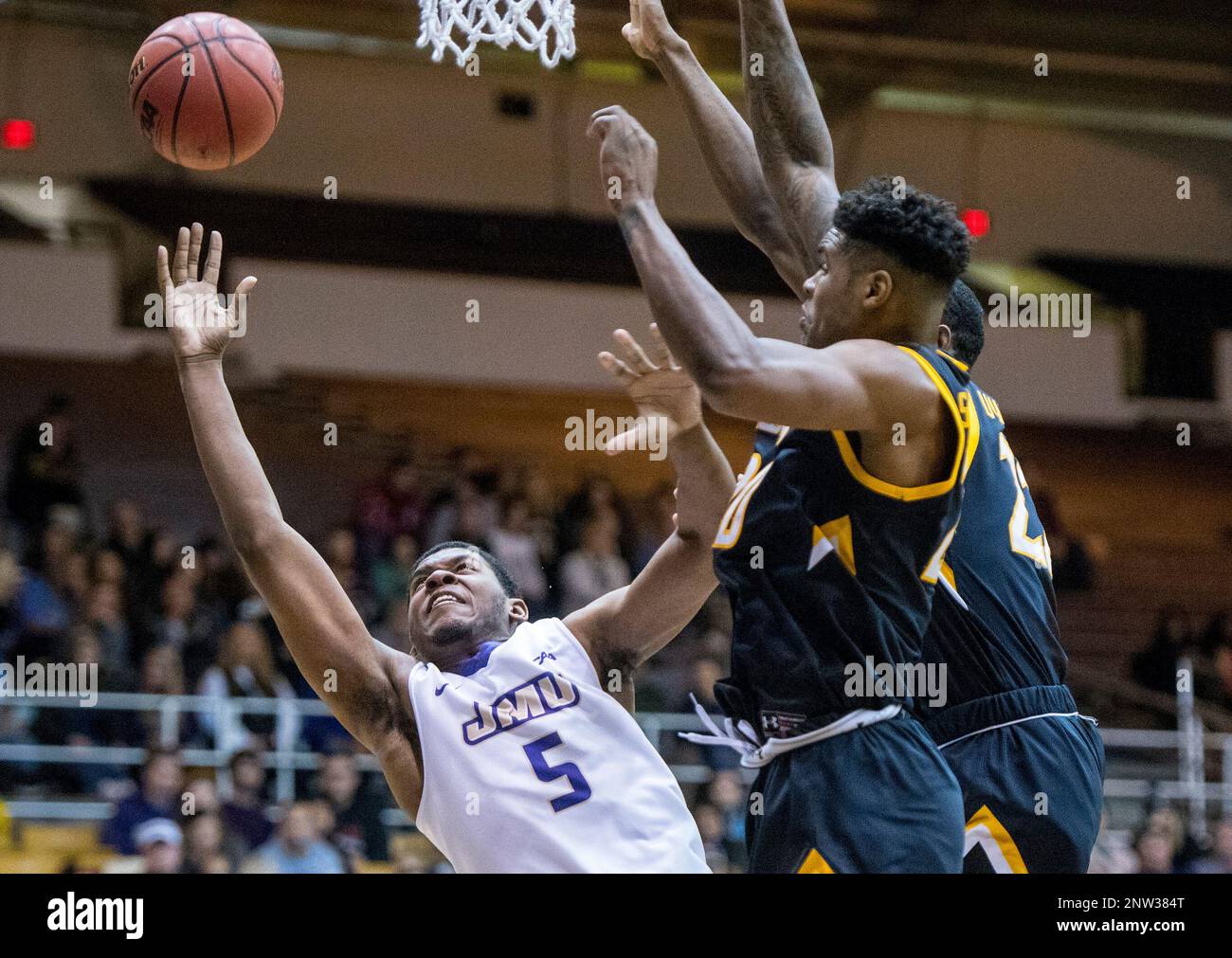 James Madison guard Darius Banks (5) fires off a shot around Towson ...