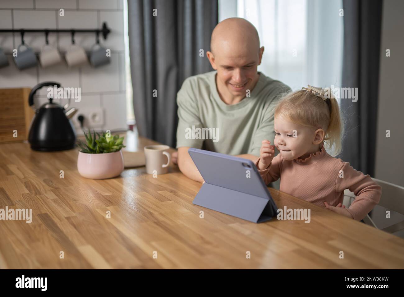 People with cochlear implant system. Kid study to hear with her father ...