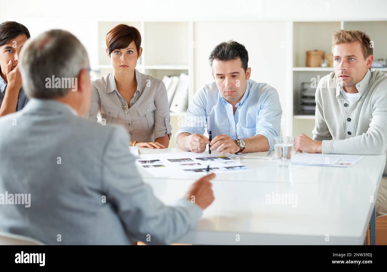 Around the meeting table. Cropped shot of a business meeting in ...