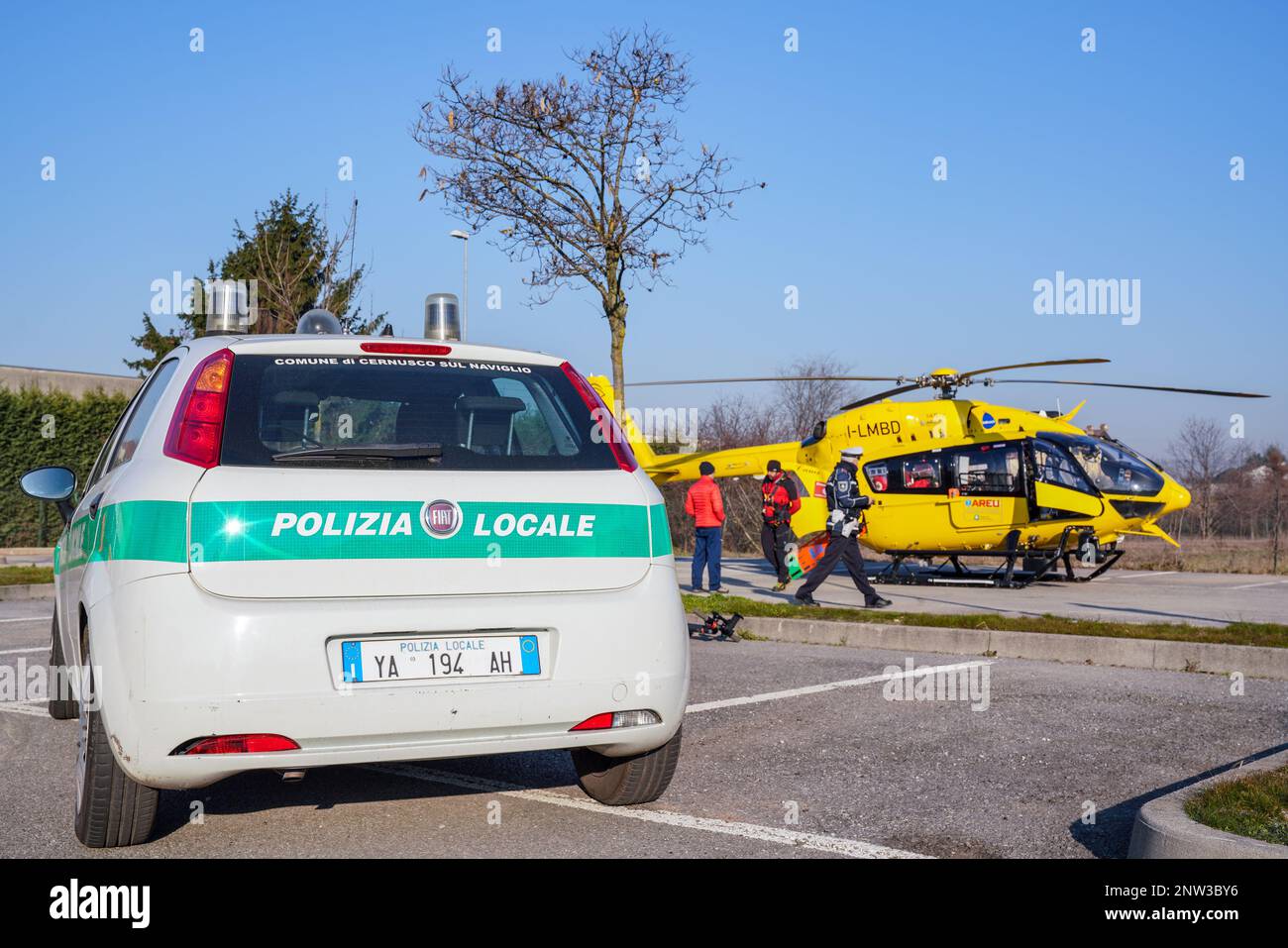Local police car and Italian Medical helicopter Airbus H145 (HORUS-1) I ...