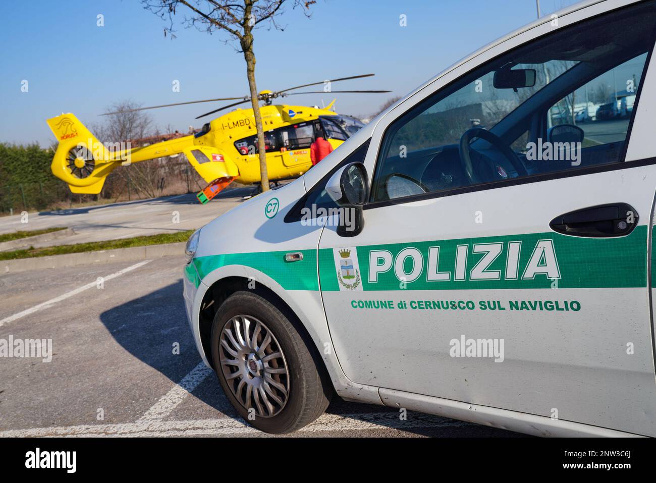 Local police car and Italian Medical helicopter Airbus H145 (HORUS-1) I ...