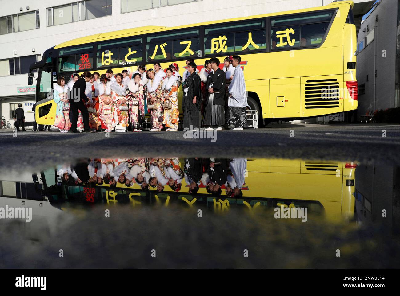 Female bus guide tour clad in kimono, pose for a photograph in front of ...