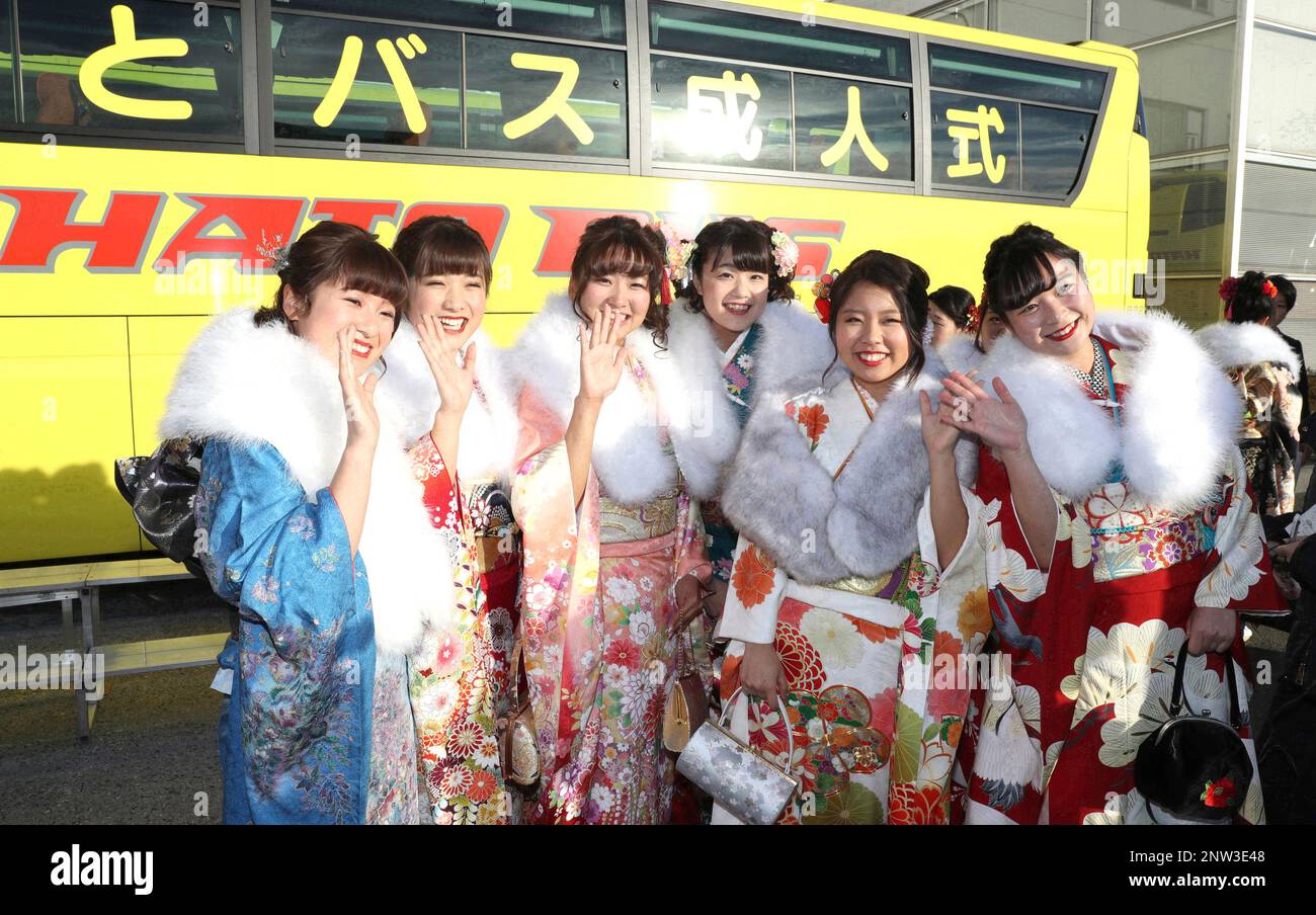 Female bus guide tour clad in kimono, pose for a photograph in front of ...