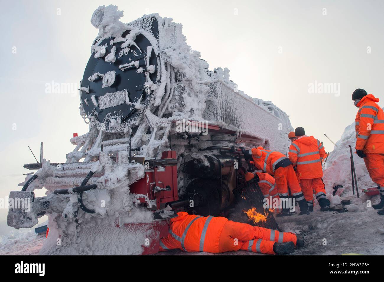 Workers de-ice parts on a classic steam locomotive Thursday Jan. 10 ...