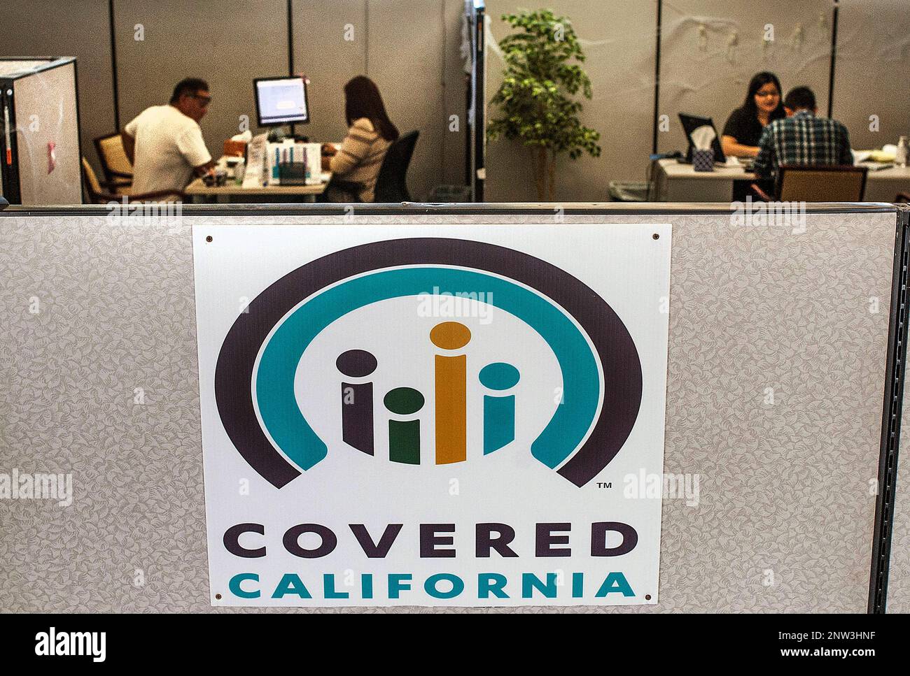 FILE - In this Nov. 1, 2016 file photo, agents help sign people up for ...