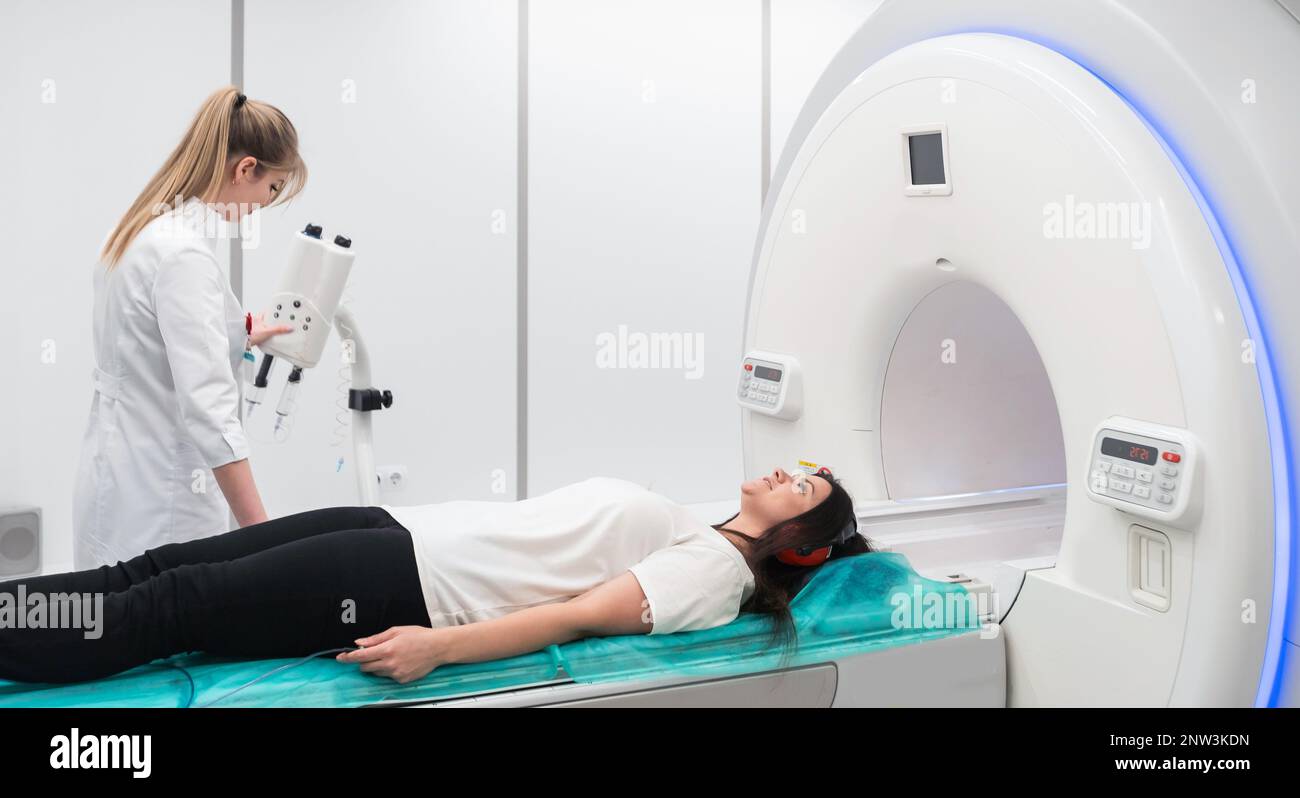 Female patient undergoing MRI - Magnetic resonance imaging in Hospital ...