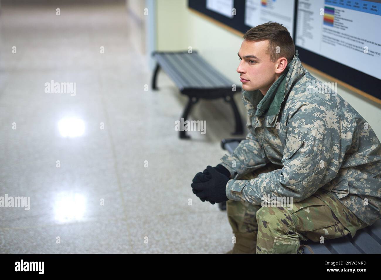 The call of dutyday 1. Shot of a young soldier sitting on a bench in ...