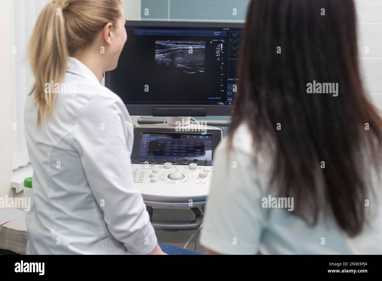 Smiling doctor, ultrasound. The doctor performed an ultrasound Stock ...
